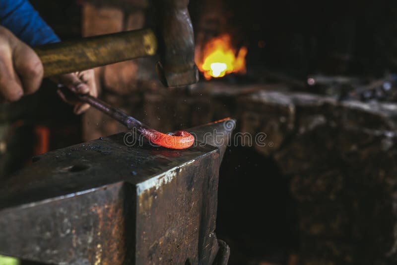 Blacksmith Manually Forging the Molten Metal on the Anvil in Smithy ...