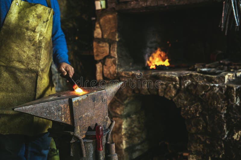 Blacksmith Manually Forging the Molten Metal on the Anvil in Smithy ...