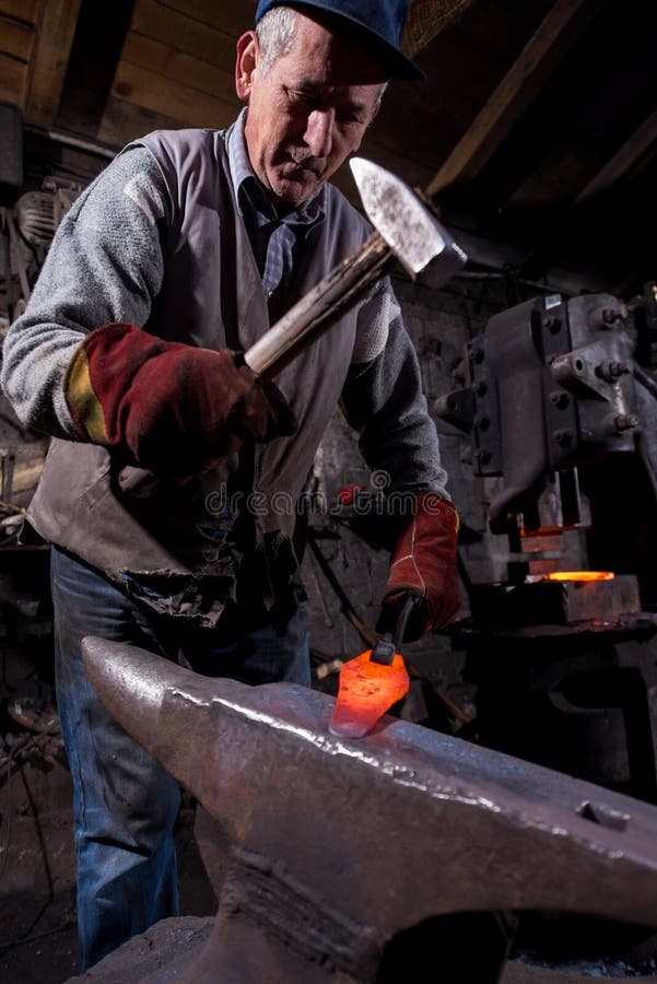 Blacksmith Manually Forging the Molten Metal Stock Photo - Image of ...