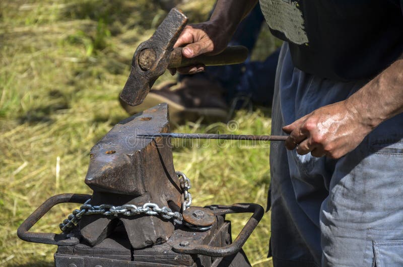 Blacksmith Manually with Hammer Working with Metal on the Anvil in the ...