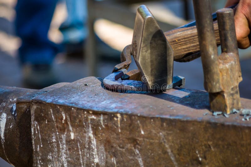 Blacksmith Performs the Forging of Hot Glowing Horseshoe on the Anvil ...