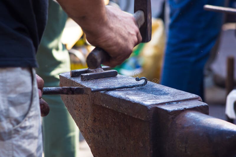 Blacksmith Performs the Forging of Hot Glowing Metal on the Anvil Stock ...