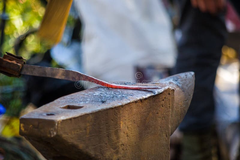Blacksmith Performs the Forging of Hot Glowing Metal on the Anvil Stock ...