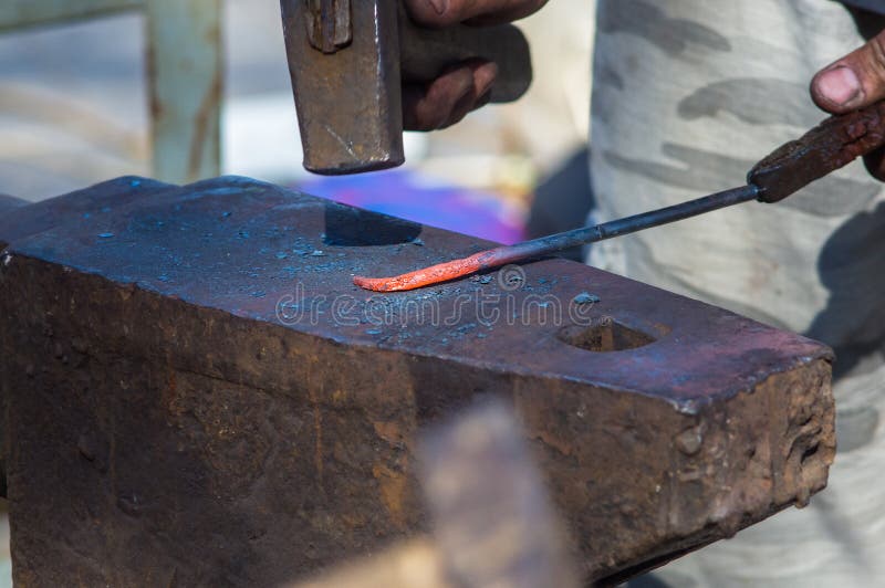 Blacksmith Performs the Forging of Hot Glowing Metal on the Anvil Stock ...