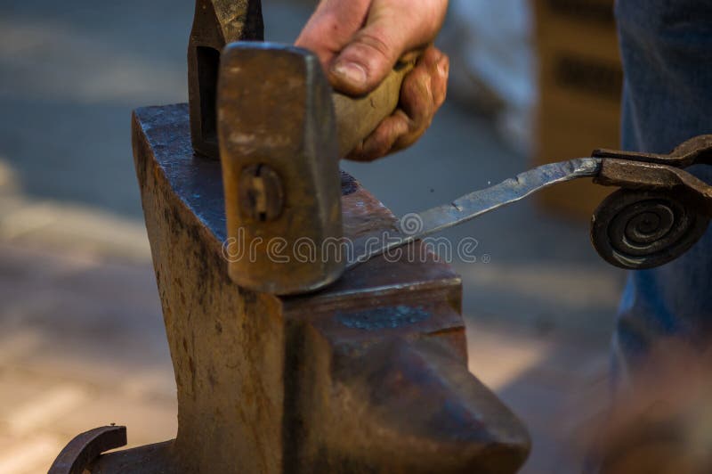 Blacksmith Performs the Forging of Hot Glowing Metal on the Anvil Stock ...