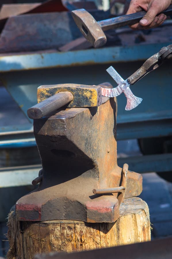 Blacksmith Performs the Forging of Hot Glowing Metal on the Anvil Stock ...