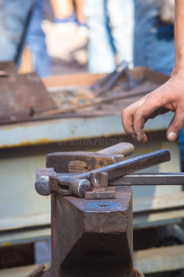 Blacksmith Performs the Forging of Hot Glowing Metal on the Anvil Stock ...