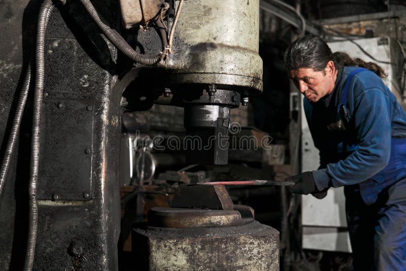 Blacksmith Processes a Hot Workpiece with a Machine Hammer Stock Photo ...