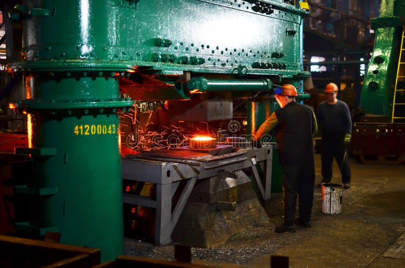 Blacksmith Processes the Red Hot Iron Under a Huge Press. Metal Forging ...
