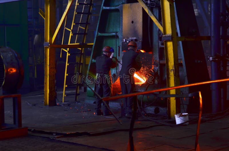 Blacksmith Processes the Red Hot Iron Under a Huge Press. Metal Forging ...