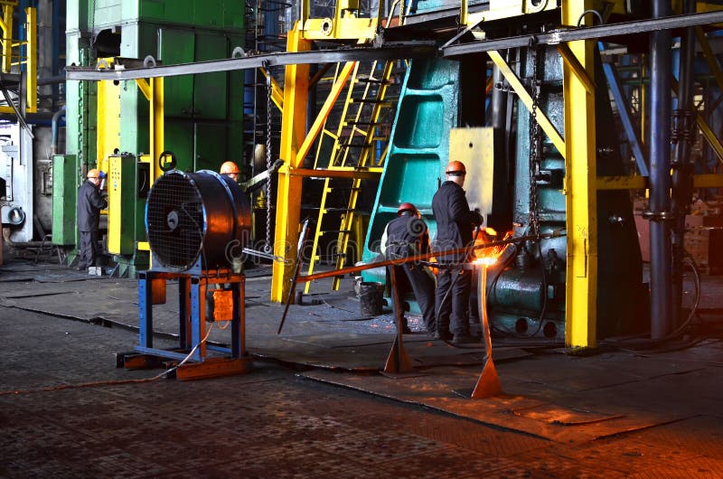 Blacksmith Processes the Red Hot Iron Under a Huge Press. Metal Forging ...