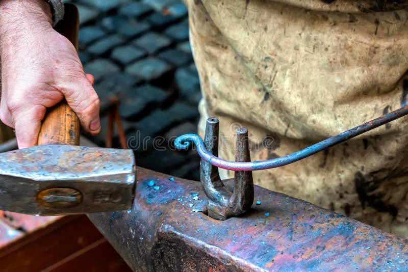 Blacksmith is Processing a Hot Metal Object of a Spiral Shape at Anvil ...