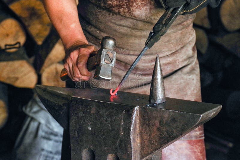Blacksmith is Processing a Hot Metal Object of a Spiral Shape at Anvil ...