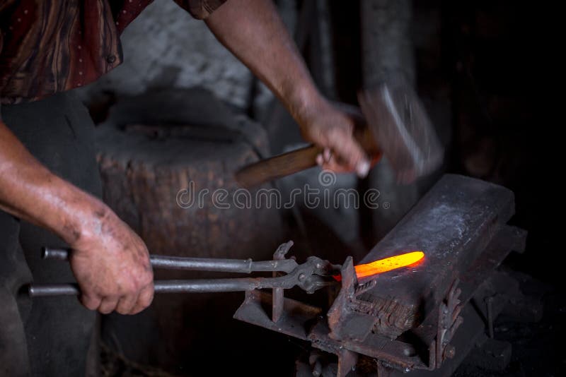 Blacksmith`s Hands at Work. in One Hand a Hammer, in the Other a ...