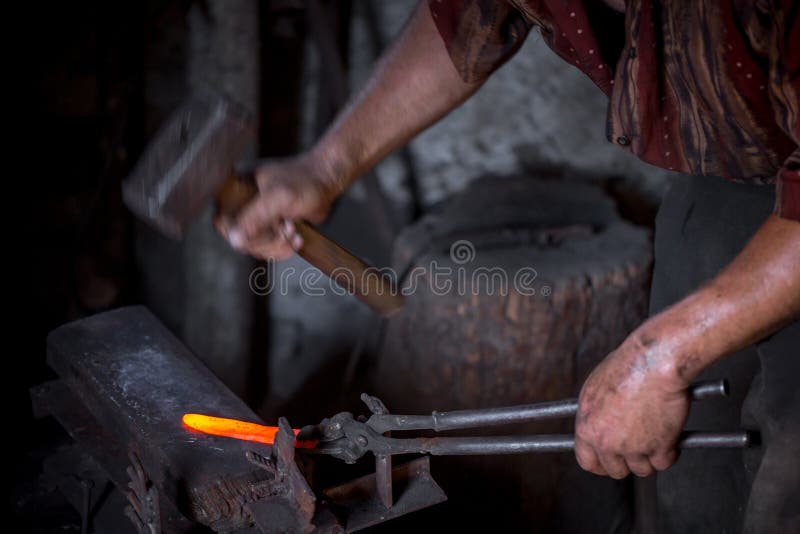 Blacksmith`s Hands at Work. in One Hand a Hammer, in the Other a ...