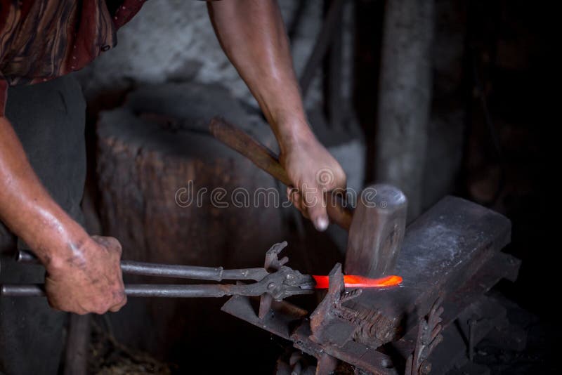 Blacksmith`s Hands at Work. in One Hand a Hammer, in the Other a ...