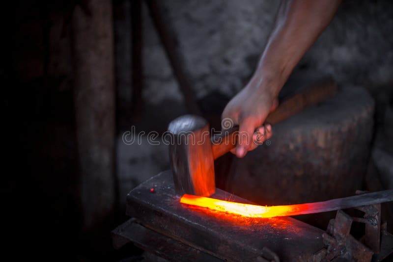 Blacksmith`s Hands at Work. in One Hand a Hammer, in the Other a ...