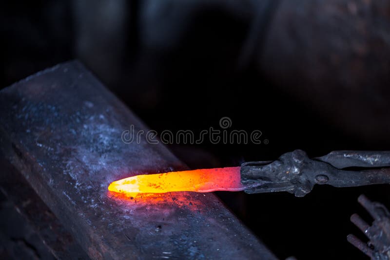 In a Blacksmith& X27;s Workshop. Blacksmith in One Hand Hold a ...