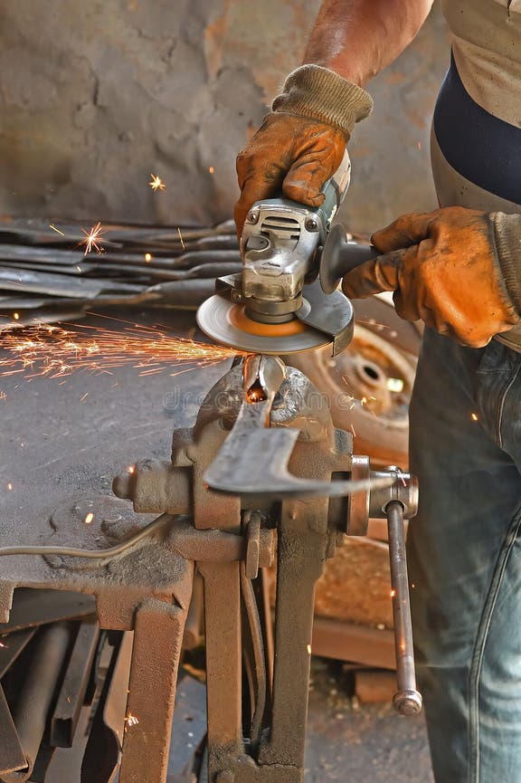 Worker Sharpens Cutting Tools in a Blacksmith S Workshop. Electric ...