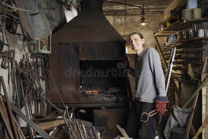 Blacksmith Standing by Forge in Workshop Stock Photo - Image of ...