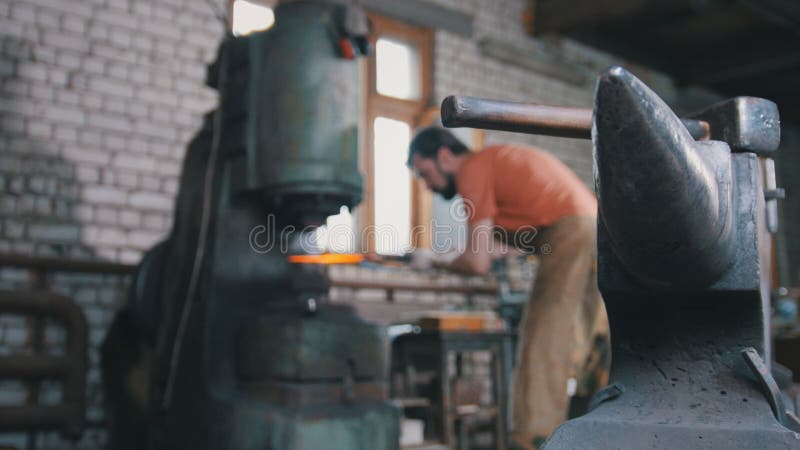Blacksmith Substitutes a Metal Piece for an Automatic Hammer Stock ...