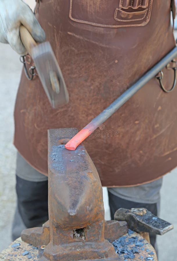 BLACKSMITH Takes the Hot Iron with a Hammer Stock Photo - Image of ...