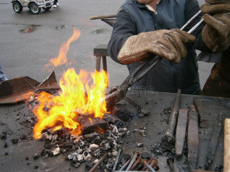 The Blacksmith Teaches The Woman. Female Hand Holding A Hammer, The Man ...