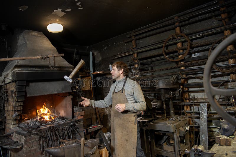 A Attractive Blacksmith Throws a Hammer in His Workshop Stock Image ...