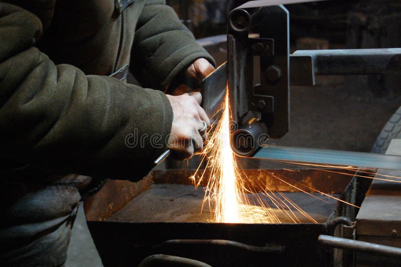 Blacksmith turning a knife stock photo. Image of activity - 64328306