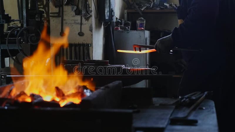 The Smith Works with Iron Against the Fire Stock Video - Video of ...