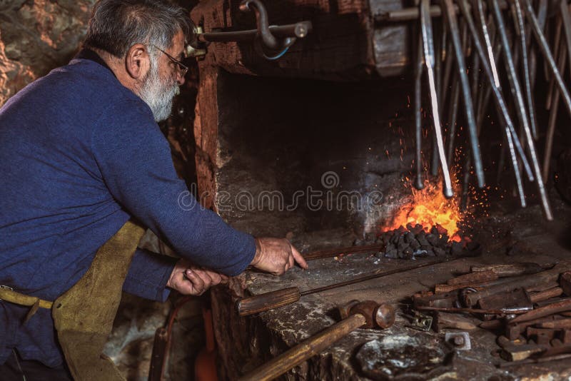 Blacksmith at Work with Glowing Irons. Stock Photo - Image of orange ...