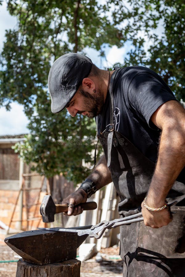 Blacksmith Working on an Anvil with Hammer. Stock Image - Image of ...