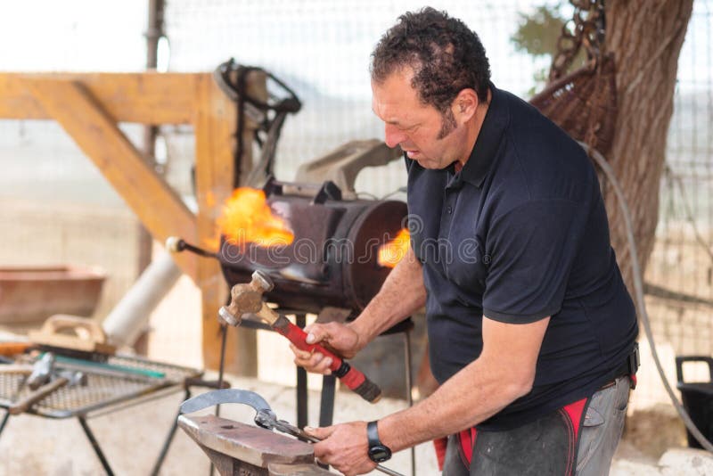 Blacksmith Working on the Anvil, Making a Horseshoe. Stock Image ...