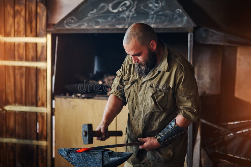 Blacksmith Working Metal with Hammer on the Anvil in the Forge Stock ...