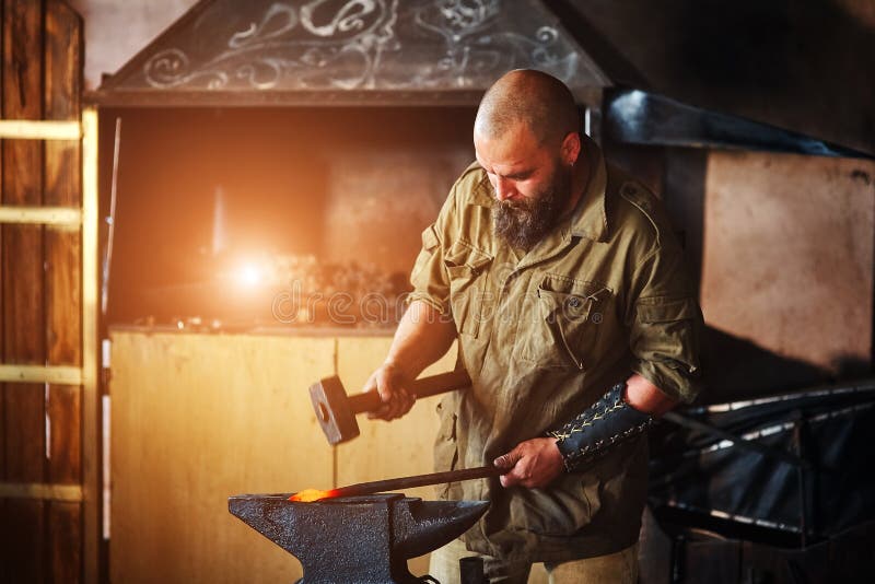 Blacksmith Working Metal with Hammer on the Anvil in the Forge Stock ...