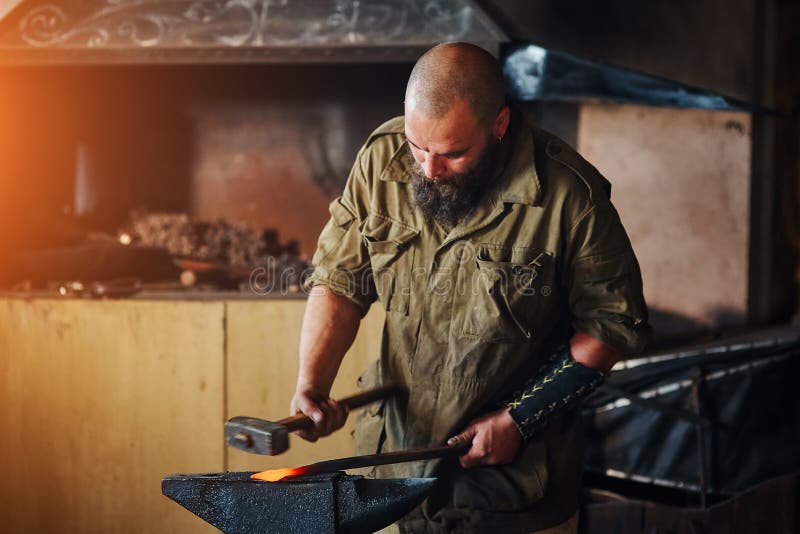 Blacksmith Working in the Forge. Manufacture of Parts and Weapons from ...