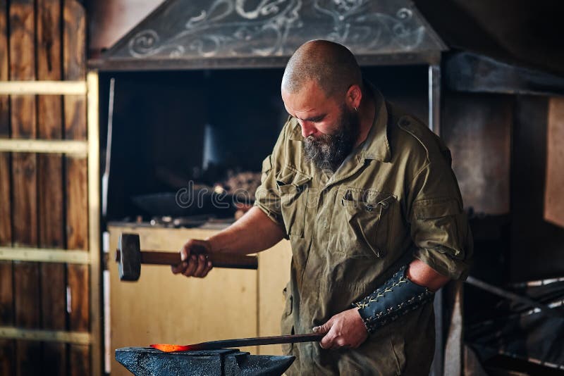 Blacksmith Working in the Forge. Manufacture of Parts and Weapons from ...