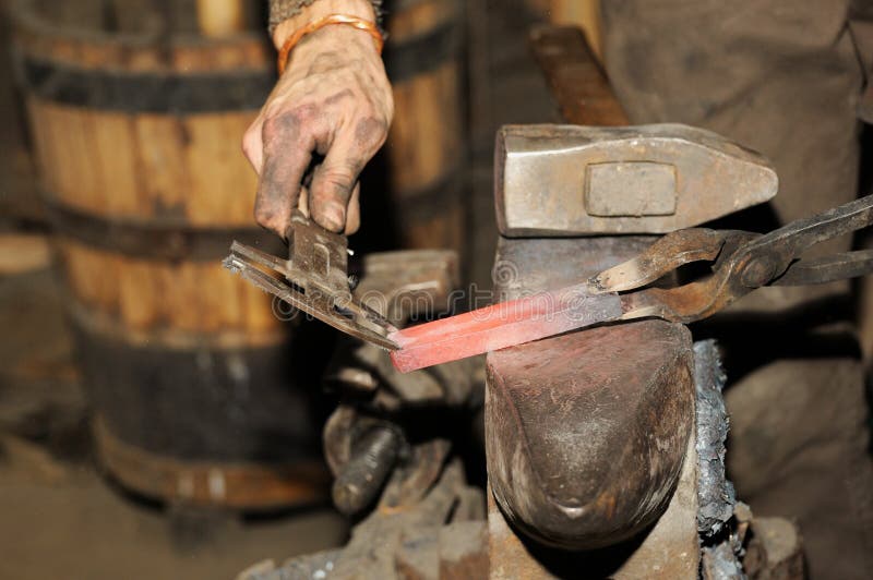 Blacksmith Working in the Forge Processes the Metal . Stock Image ...