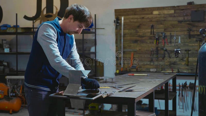 Blacksmith Working with Metal Decorative Detail at His Workshop Stock ...