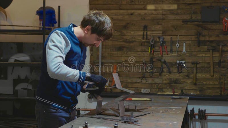 Blacksmith Working with Metal Decorative Detail at His Workshop Stock ...