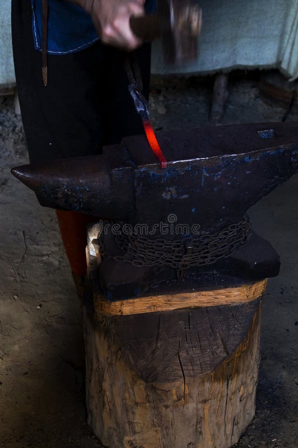 Blacksmith Working Metal with Hammer on the Anvil in the Forge Stock ...