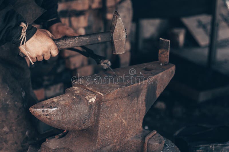 Blacksmith Working Metal with Hammer and Pincers on Anvil in Forge ...