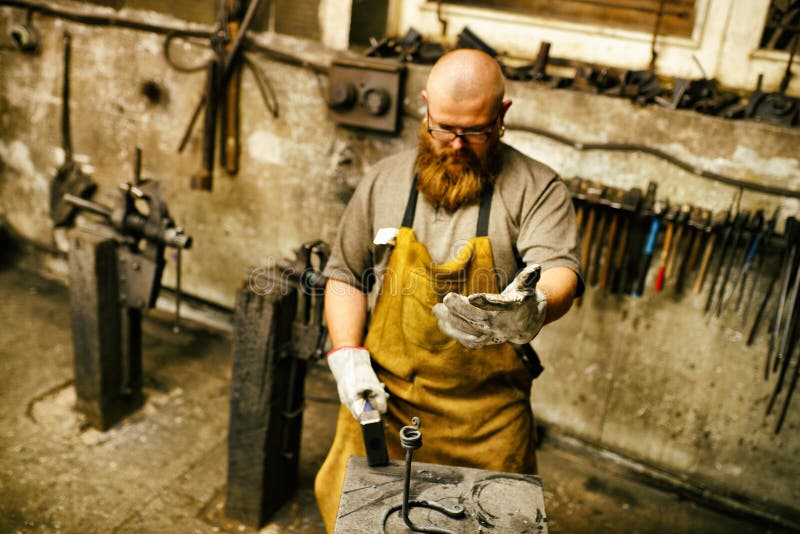 Blacksmith Working In Workshop Stock Image - Image of holding ...