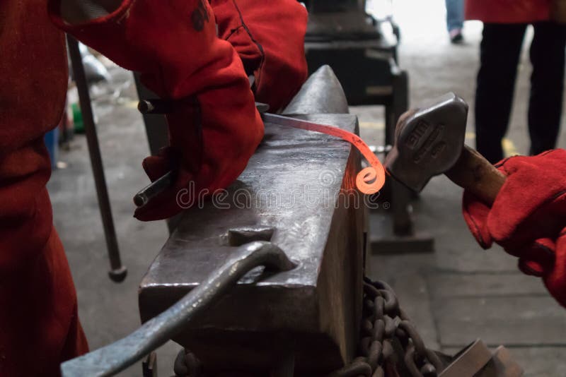 Blacksmiths Forge with Two People Working on Metal Using Hammer and ...