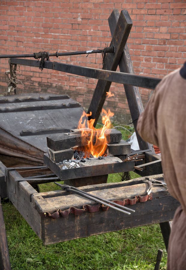 Blacksmiths Work with Metal, Heating it in a Fire Stock Image - Image ...
