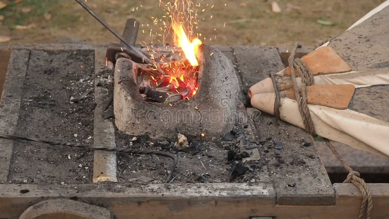 Two Blacksmiths in Working Uniforms Make a Metal Fence in the Forge ...