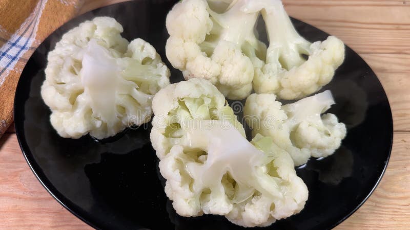 Blanched Cauliflower Pieces on Big Black Plate on Rustic Table Stock ...