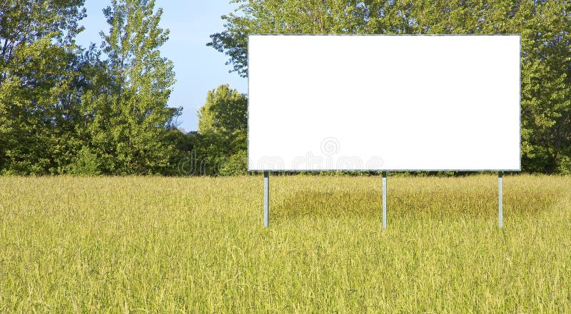 Blank Advertising Signboard in a Green Field with Trees on Background ...