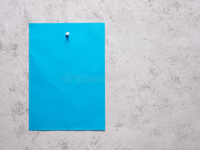 Blank Blue Sheet of Paper Pinned To a White Concrete Wall Stock Photo ...