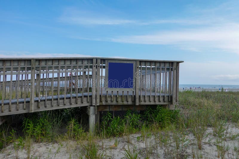 A Blank Blue Sign on the Side of the Fence on a Wooden Boardwalk ...